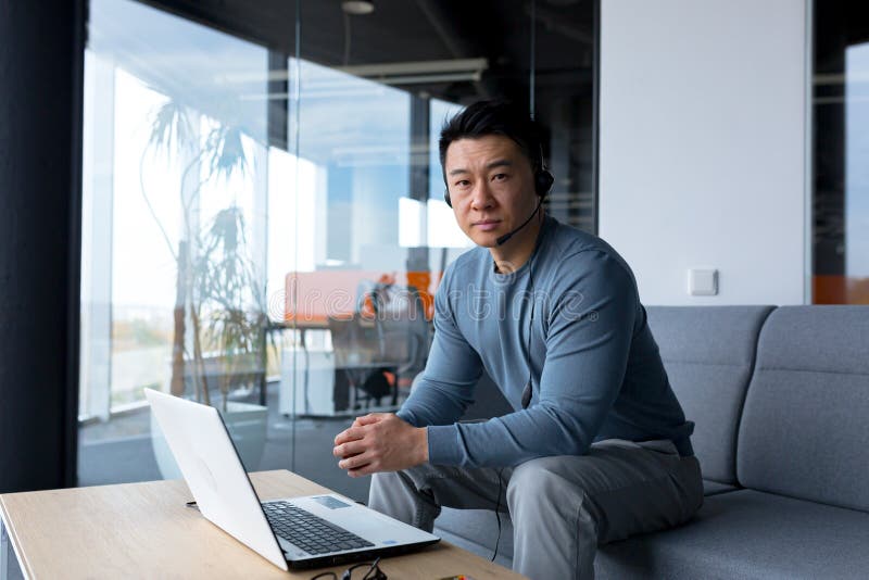 Portrait of an Asian Call Center Employee, Man Working with Headset and ...