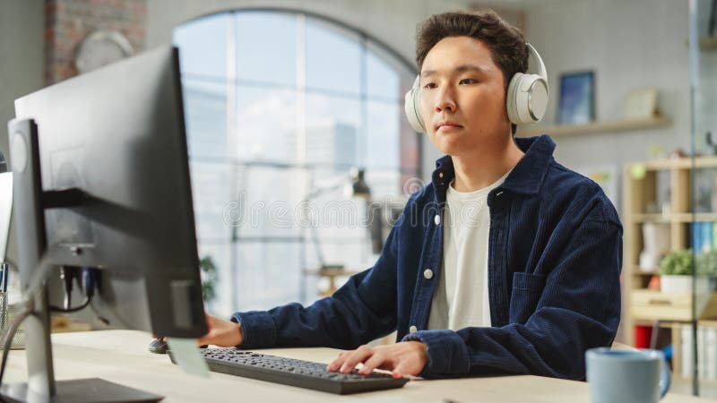 Portrait of Asian Creative Young Man Focused while Using Computer in ...