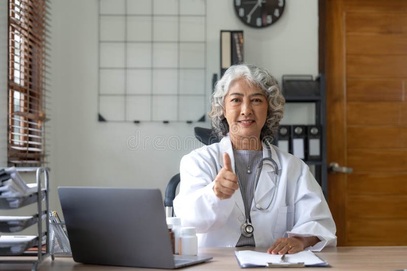Portrait of Asian Doctor Working at Her Table in Clinic Stock Image ...