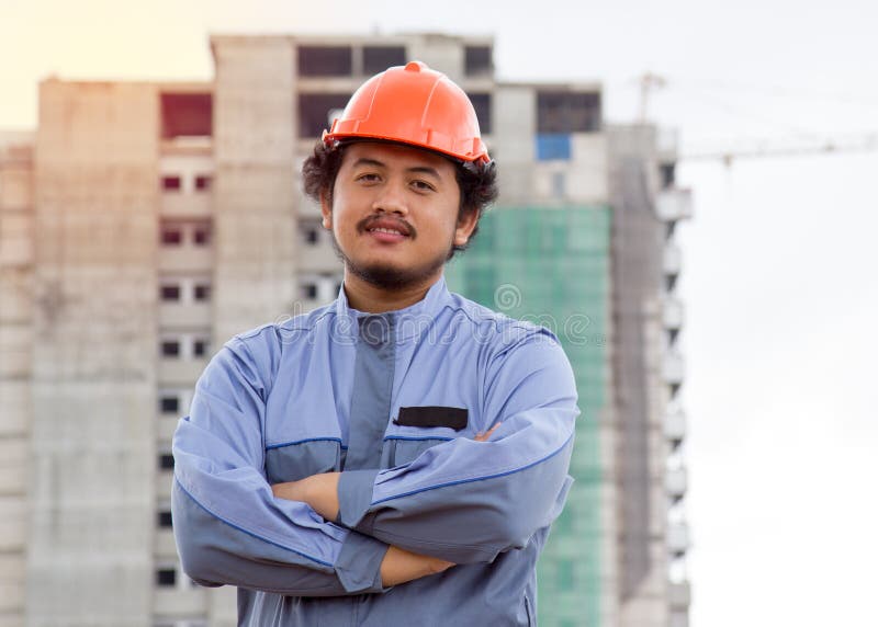 Asian Engineer with Construction Building and Crane As Background Stock ...
