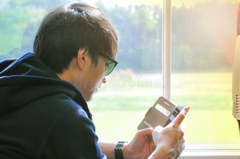 Portrait of Asian Man Sitting in the Train and Using the Mobile Stock ...