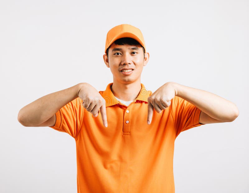 Portrait Asian Smiling Young Delivery Man Pointing Down Something with ...