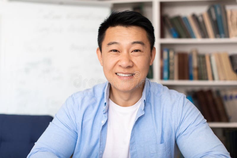 Asian Teacher Man Having Class Writing On Whiteboard In Classroom Stock