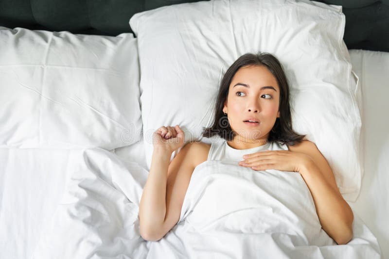 Portrait Of Asian Woman Lying In Bed With Shocked Face Looking Startled And Upset Gasping From 9634