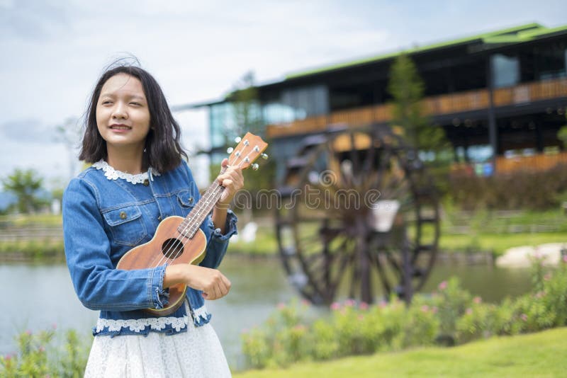Portrait Asian Young Girl Wear Jean Jacket And White Skirt Playing