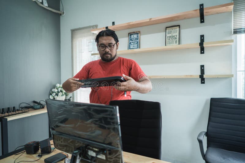 Portrait of Asian Young Man Fix a Problem with Keyboard of Personal ...