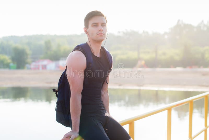 Portrait of Athletic Man Sitting on Pier Near Pond Stock Photo - Image ...