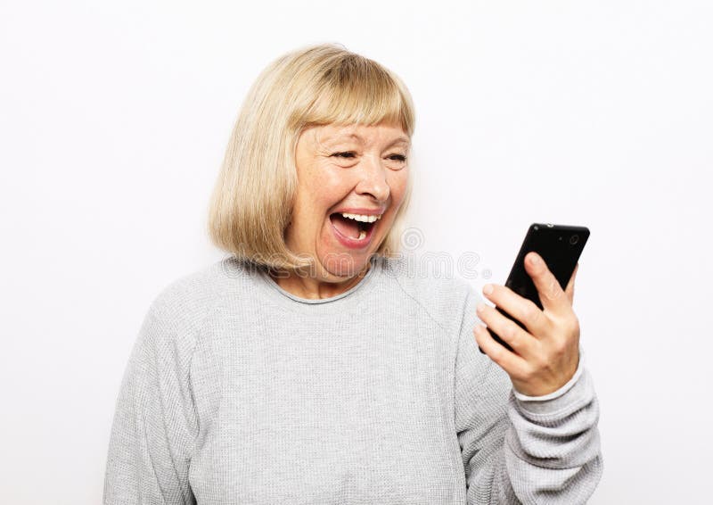 Portrait Of Attractive Blond Senior Woman Talking By Mobile Phone Over