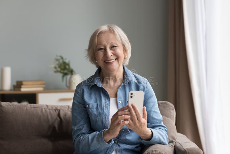 Portrait of Attractive Elderly Woman Pose for Camera with Cellphone ...
