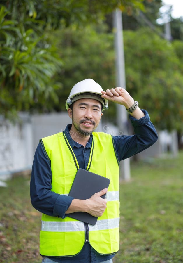 Portrait of an Attractive Electrician in Uniform on a Construction Site ...