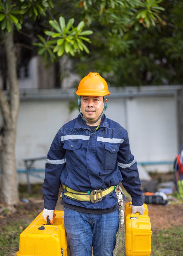 Portrait of an Attractive Electrician in Uniform on a Construction Site ...