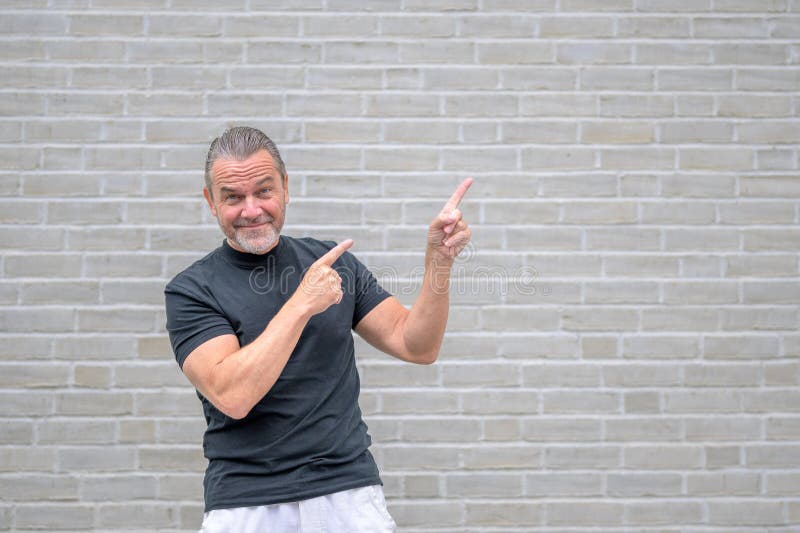 Promotional Photo of an Attractive Serious Man Pointing To the Right ...