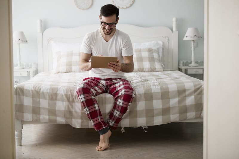 Portrait of Attractive Man Using Tablet in Bedroom Stock Photo - Image ...