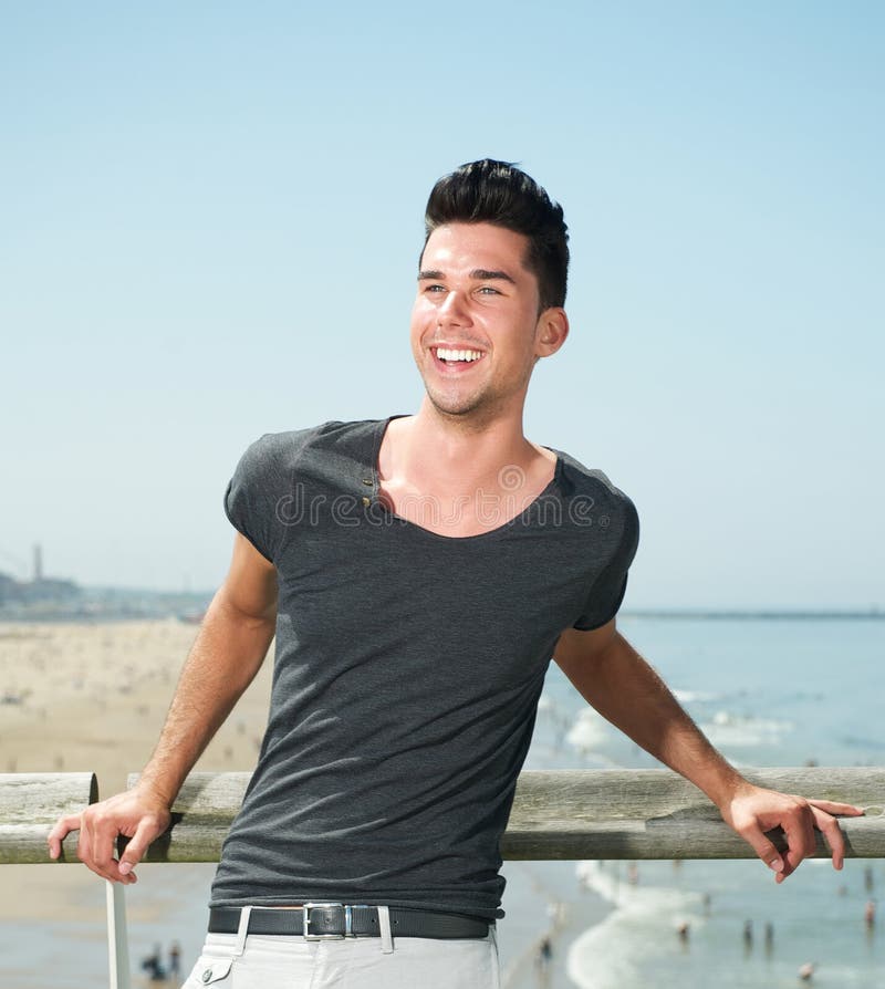 Portrait of an Attractive Young Man Smiling at the Beach Stock Photo ...