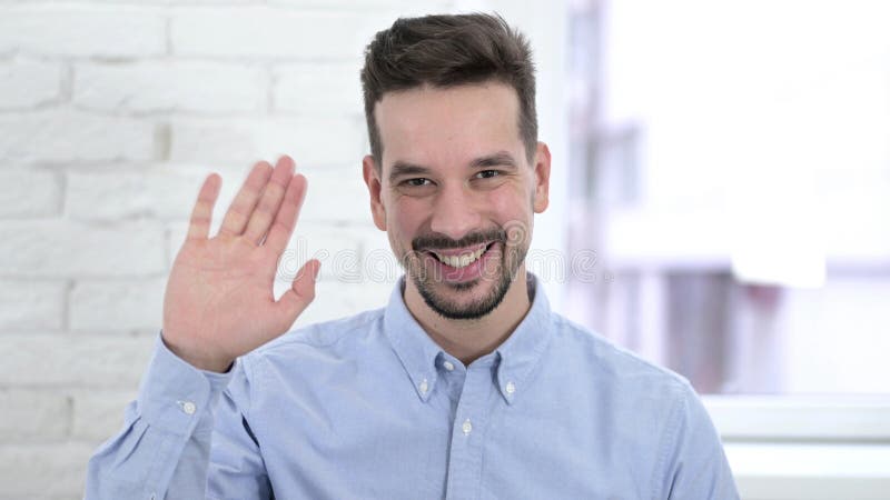 Portrait of Attractive Young Man Waving at the Camera Stock Image ...