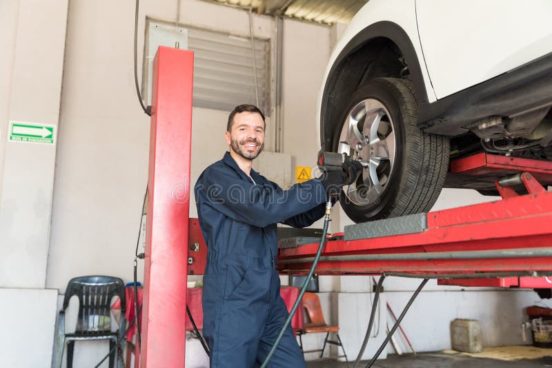 Auto Engineer Fixing Tire Nuts with Electric Spanner in Garage Stock ...