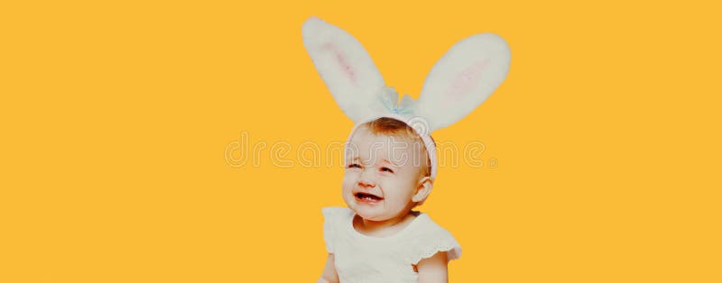 Portrait of Baby with Rabbit Ears Crying on Yellow Background Stock ...
