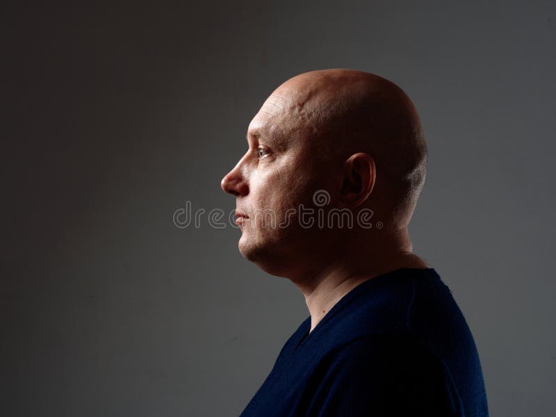 Portrait of a Bald Cheerful Man in Profile on a Black Background Stock ...