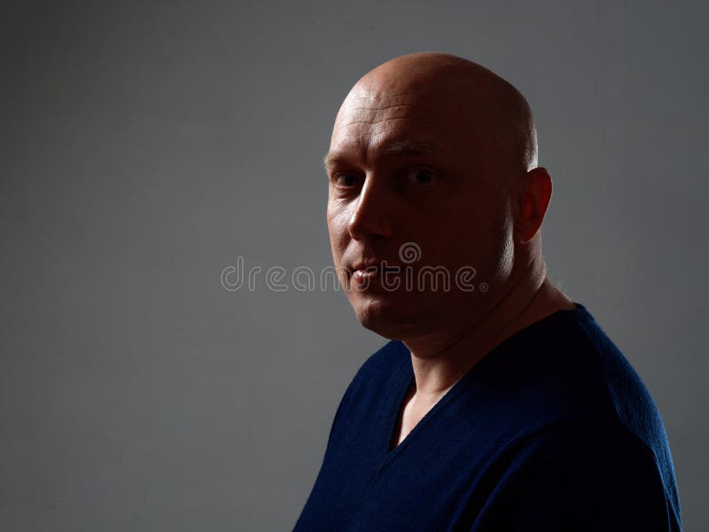 Portrait of a Bald Cheerful Man in Profile on a Black Background Stock ...