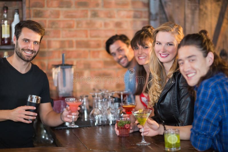 Portrait of Bartender Serving Drinks To Happy Customers Stock Photo ...
