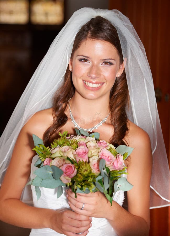 Portrait of a Beaming Bride. a Blushing Bride Holding a Bouquet on Her ...