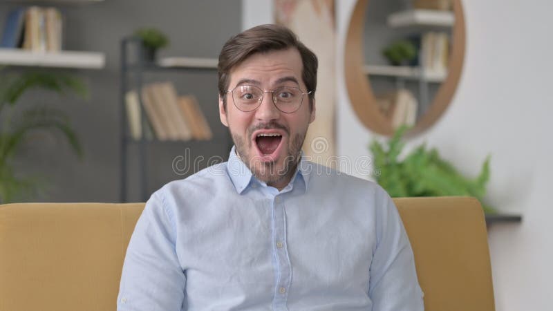 Shocked Young Man Wondering in Awe at Home Stock Image - Image of ...