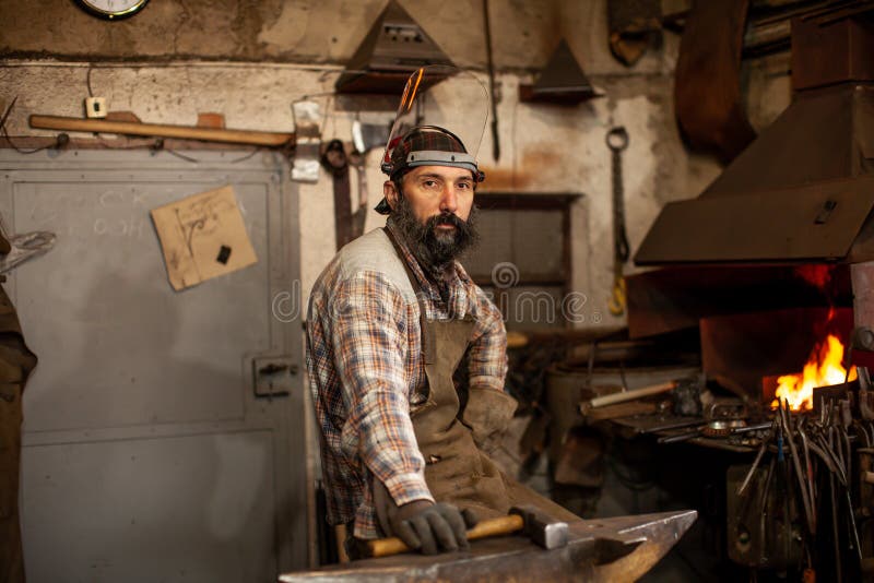The Portrait of Bearded Blacksmith Preparing To Work in His Workshop ...