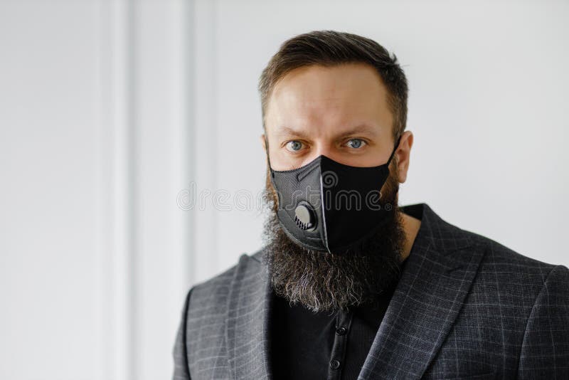 Portrait of a Bearded Man in a Black Medical Mask on a Light Background ...