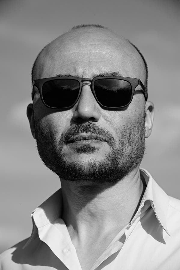 Portrait of a Bearded Man Wearing Sunglasses Against the Sky. Stock ... Portrait of a Bearded Man Wearing Sunglasses Against the Sky. Stock ...