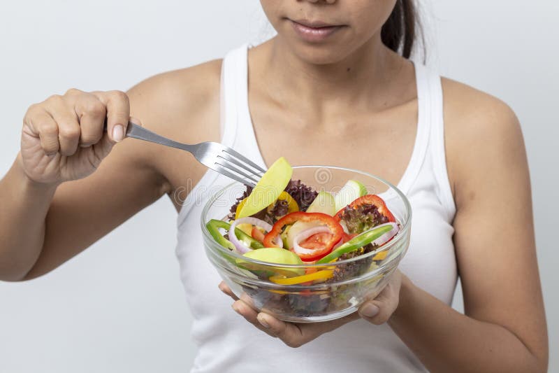 Portrait Of Beautiful Asian Young Woman Eating Vegetable Salad Isolated