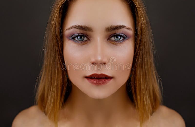 Portrait Of Beautiful Blonde Woman With Blue Eyes Isolated On Grey