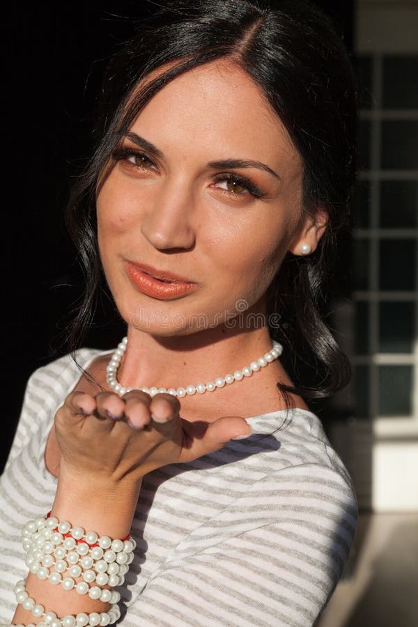 Portrait Of A Beautiful Fashionable Brunette Woman In A Gray Dress