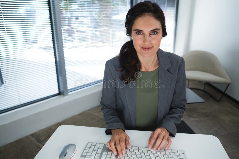 Beautiful Female Executive Working at Desk Stock Image - Image of ...