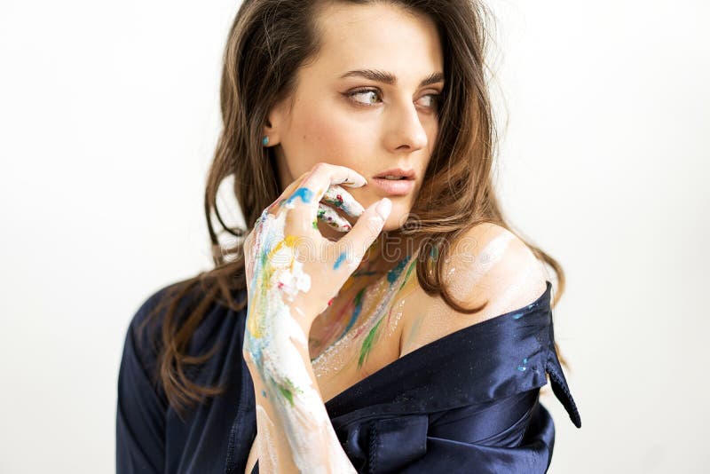 Portrait of a Beautiful Girl in Paint Posing on a White Background ...