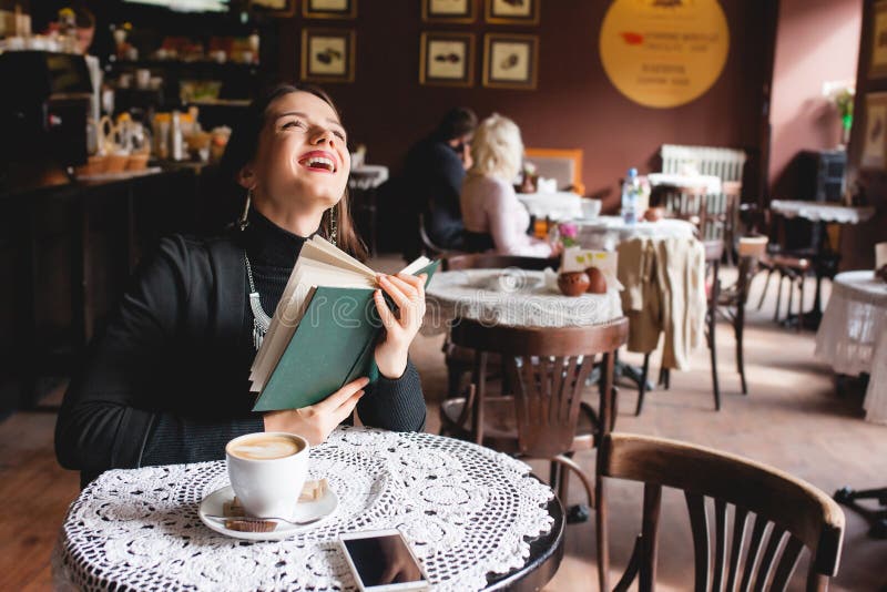Portrait of a Beautiful Girl Reading Book in Cafe Stock Photo - Image ...