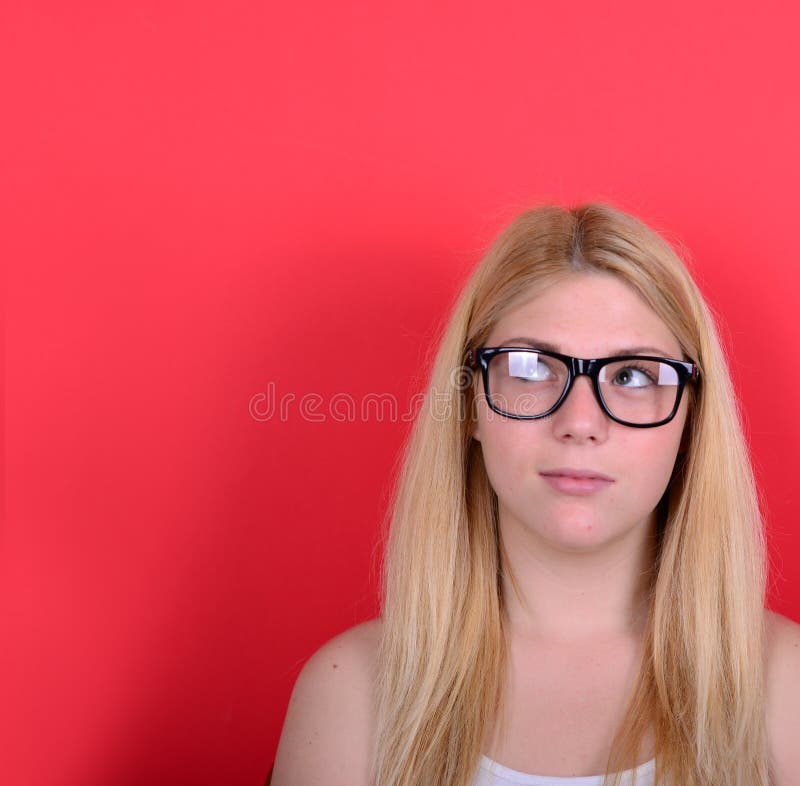 Portrait of Beautiful Girl Thinking and Looking Up Against Red B Stock ...