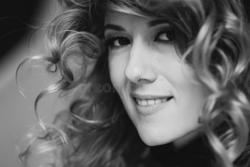 Portrait Of A 36 Year Old Woman With Curly Hair And Brown Slanting Eyes