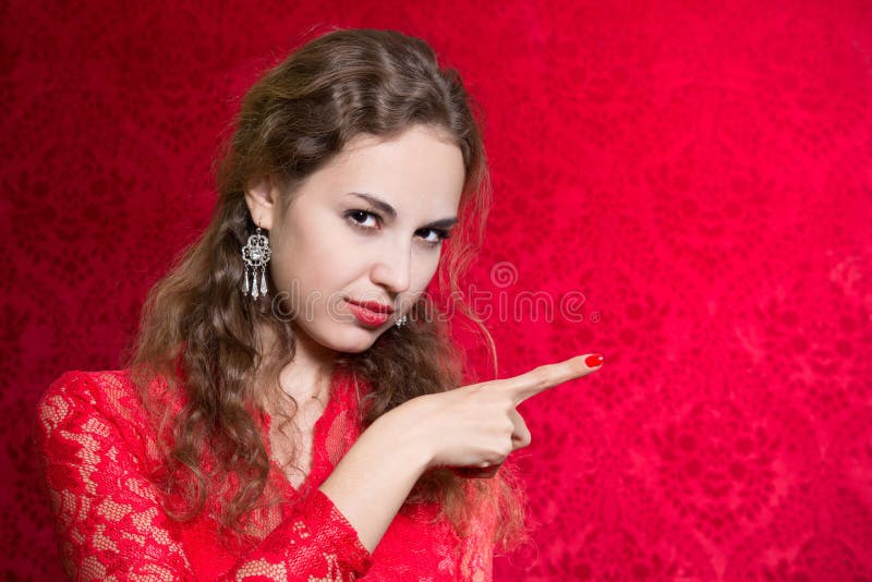 Portrait Of A Beautiful Happy Young Woman Pointing Finger At A R Stock
