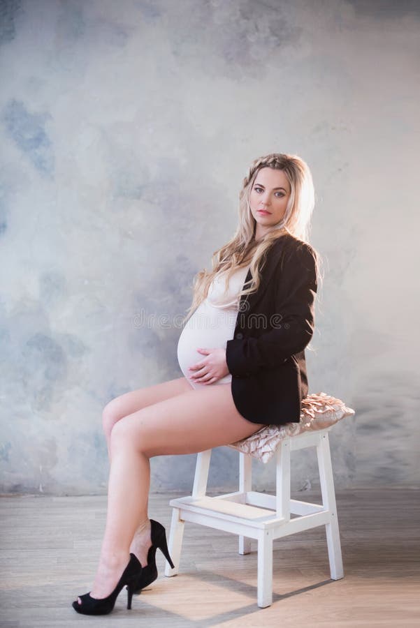 Portrait Of A Beautiful Pregnant Woman In White Lingerie Stock Image