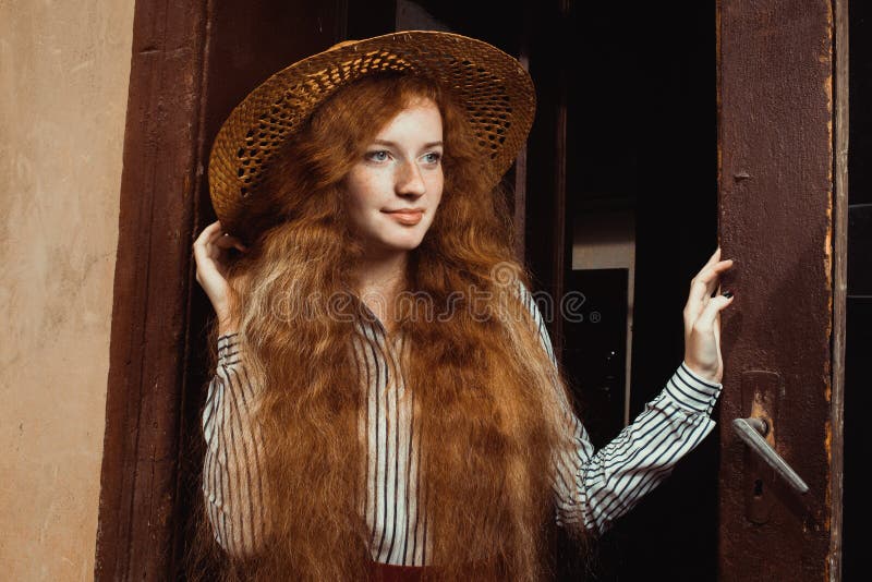 Portrait Of Beautiful Red Haired Model With Long Hair In Straw H Stock