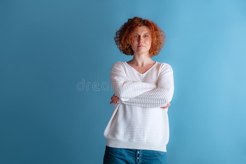 Portrait Of Beautiful Red Headed Woman With Curly Hair And Bright Blue