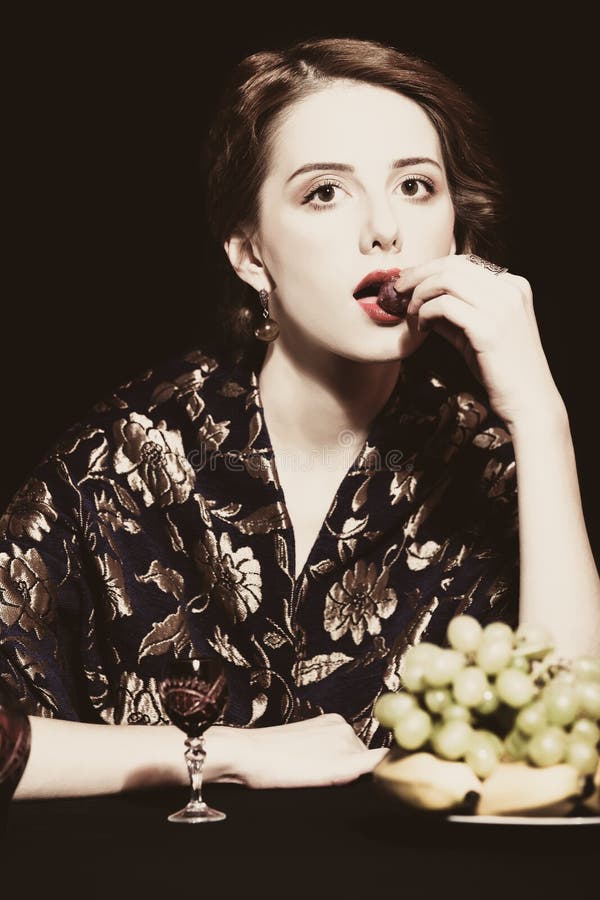Rich woman with grapes. stock photo. Image of redhead - 128099284