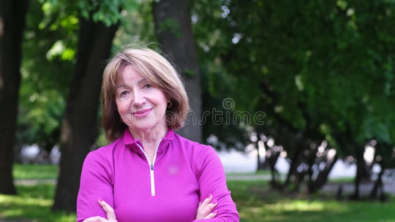 Portrait Of Beautiful Senior Woman Looking At Camera And Smiling While