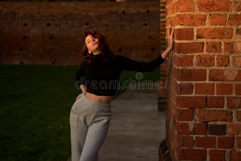 Portrait Of A Beautiful Sensual Redhead Girl Posing In Sunset Sunlight