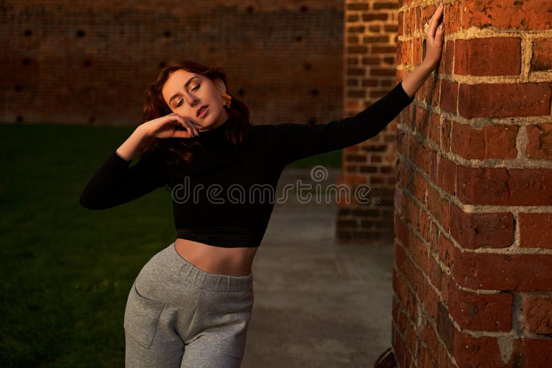 Portrait Of A Beautiful Sensual Redhead Girl Posing In Sunset Sunlight