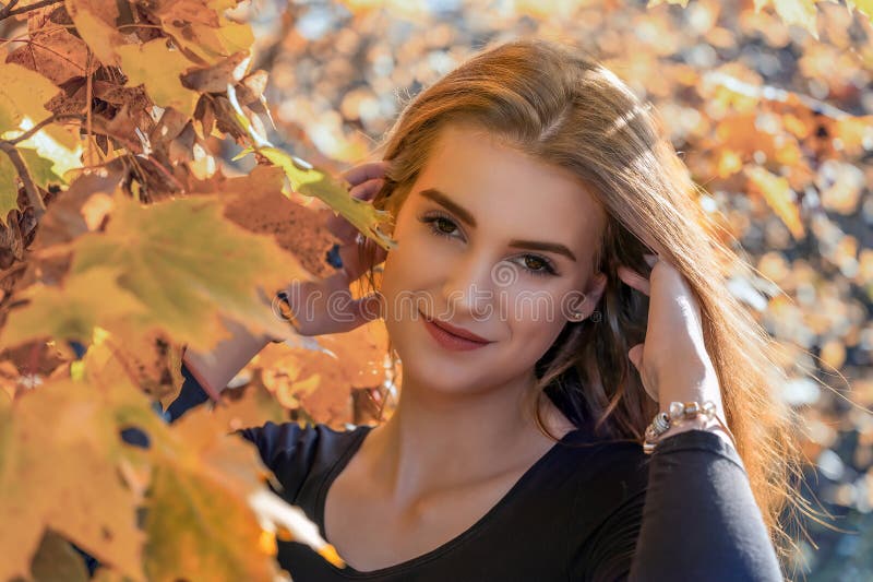 Portrait of Beautiful Smiling Girl Posing by Maple Trees Stock Photo ...