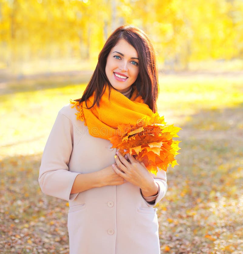 Portrait Beautiful Smiling Young Woman With Yellow Maple Leafs In Sunny