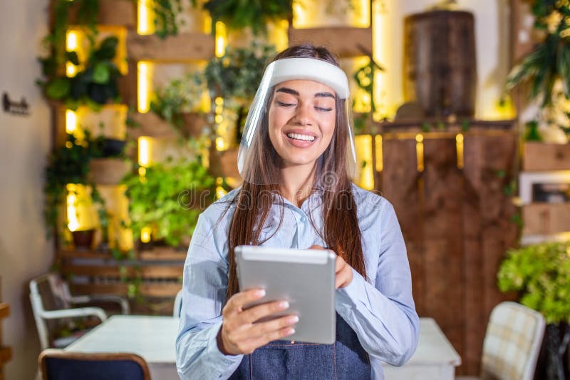 Female Waitress Wearing Face Shield, Visor Serves the Coffee in ...
