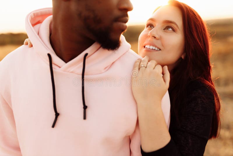 Portrait Of Beautiful White Woman Gently Cuddle Attractive African