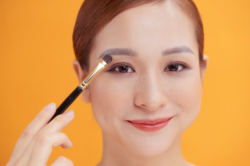 Portrait of a Beautiful Woman Applying Eye Shadow Stock Image - Image ...